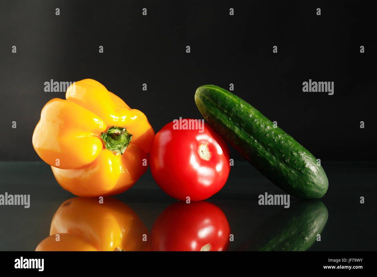 Color vegetables on dark background with reflection Stock Photo - Alamy