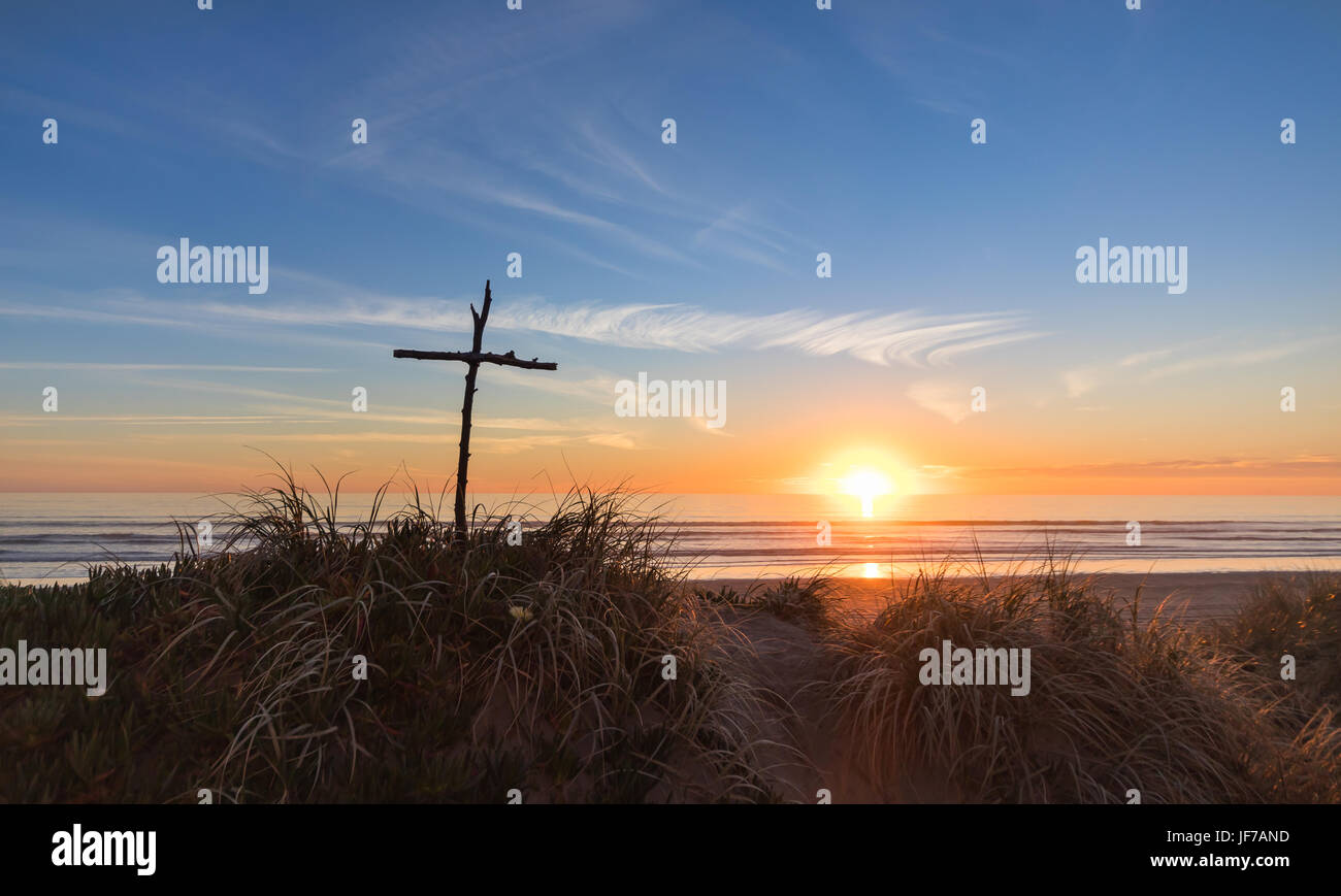 Cross on a sand dune on a beach as the sunsets Stock Photo - Alamy