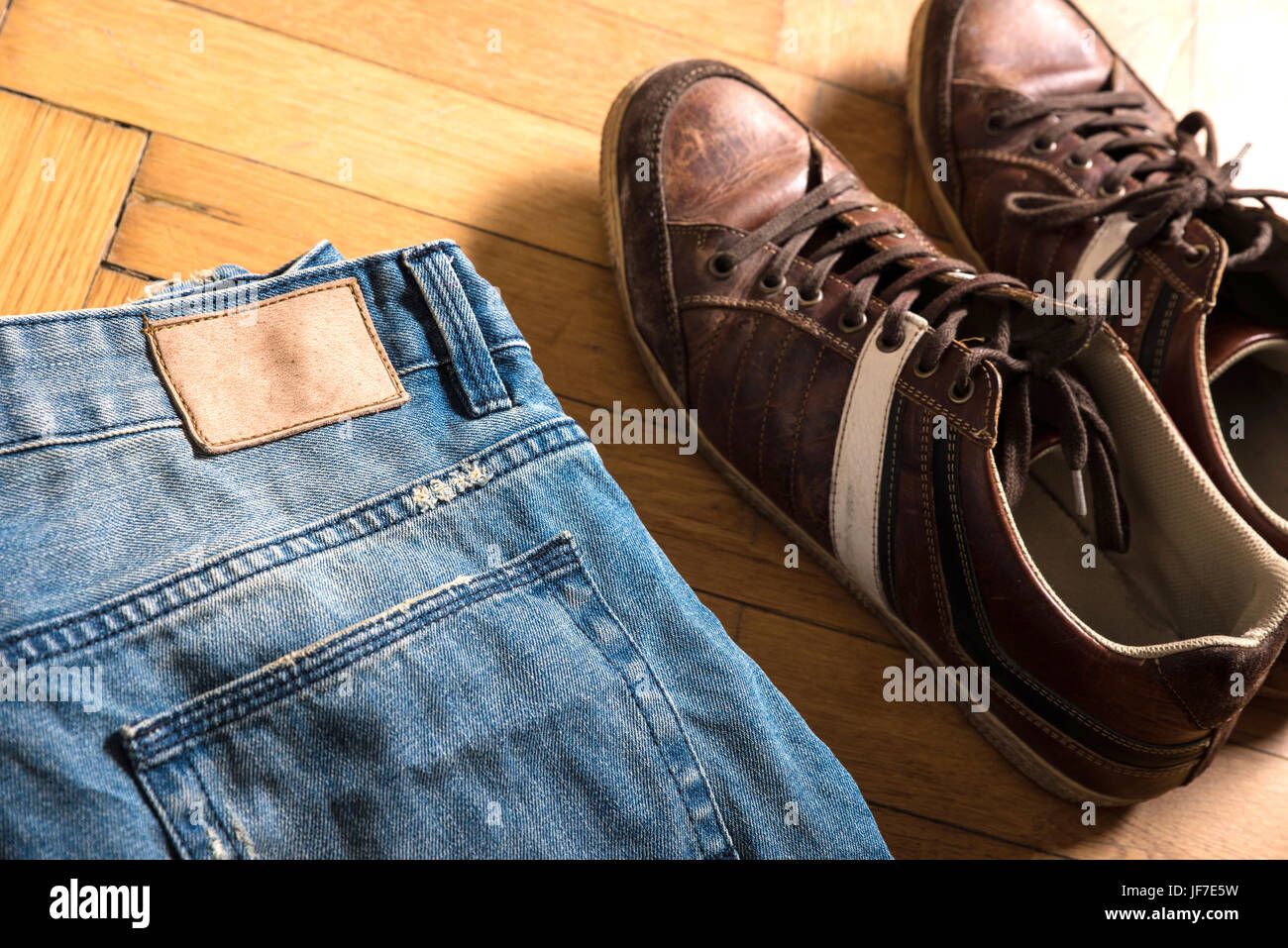 Shoes and jeans on the floor Stock Photo - Alamy