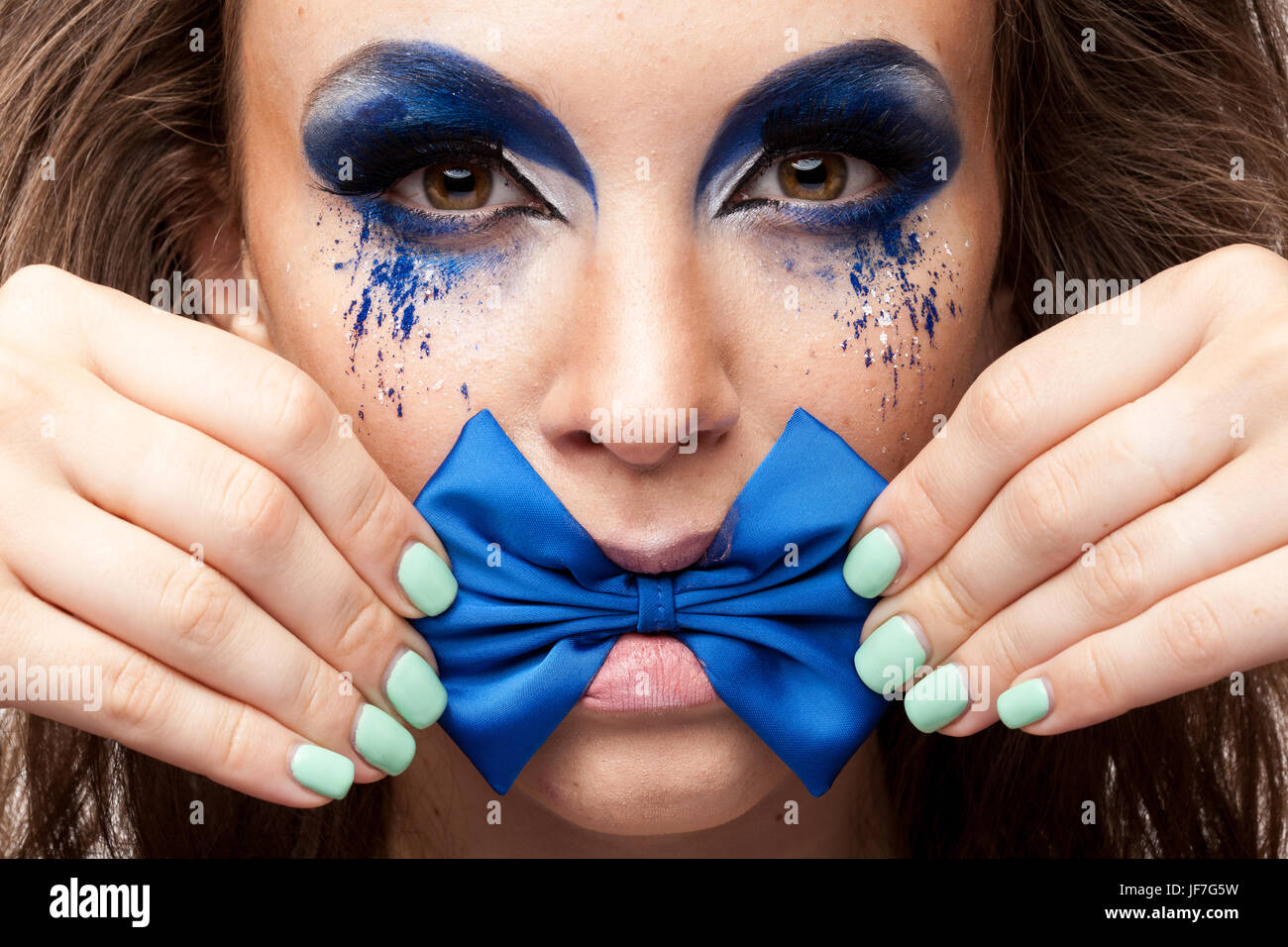 Girl holding a bow in mouth Stock Photo - Alamy