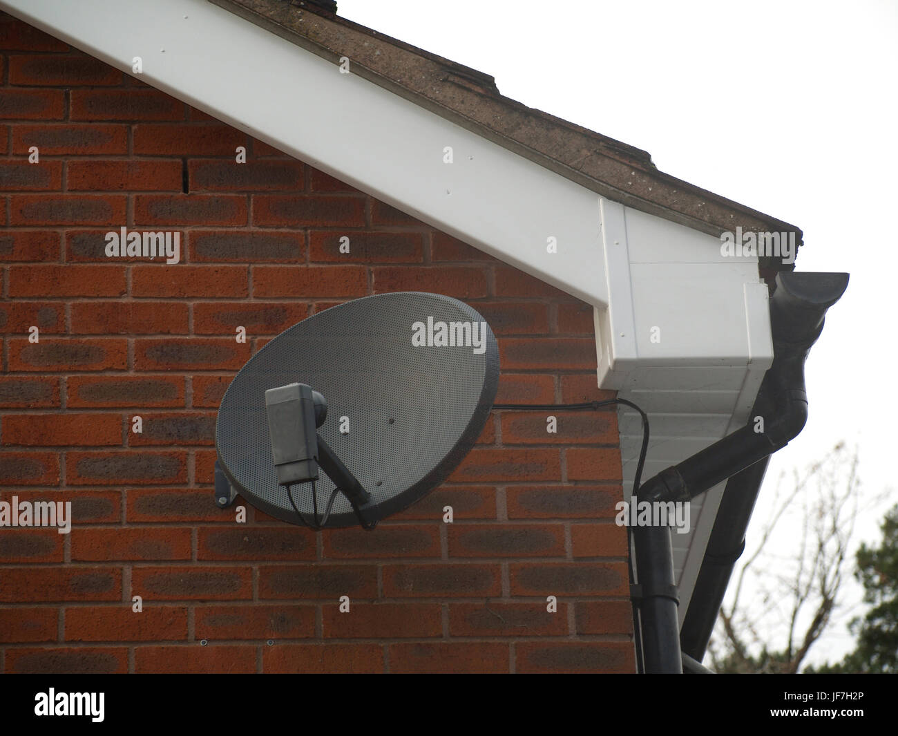 Sky dish mounted on traditional red brick British house Stock Photo - Alamy