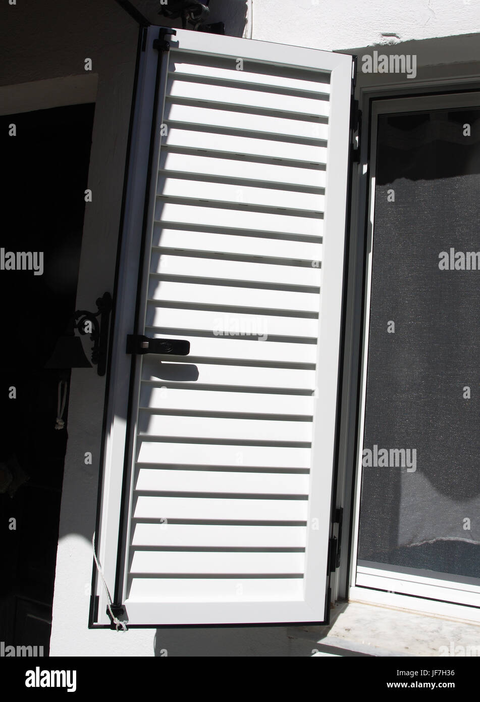 Modern white shutters on traditional Greek village house in Xanthates ...