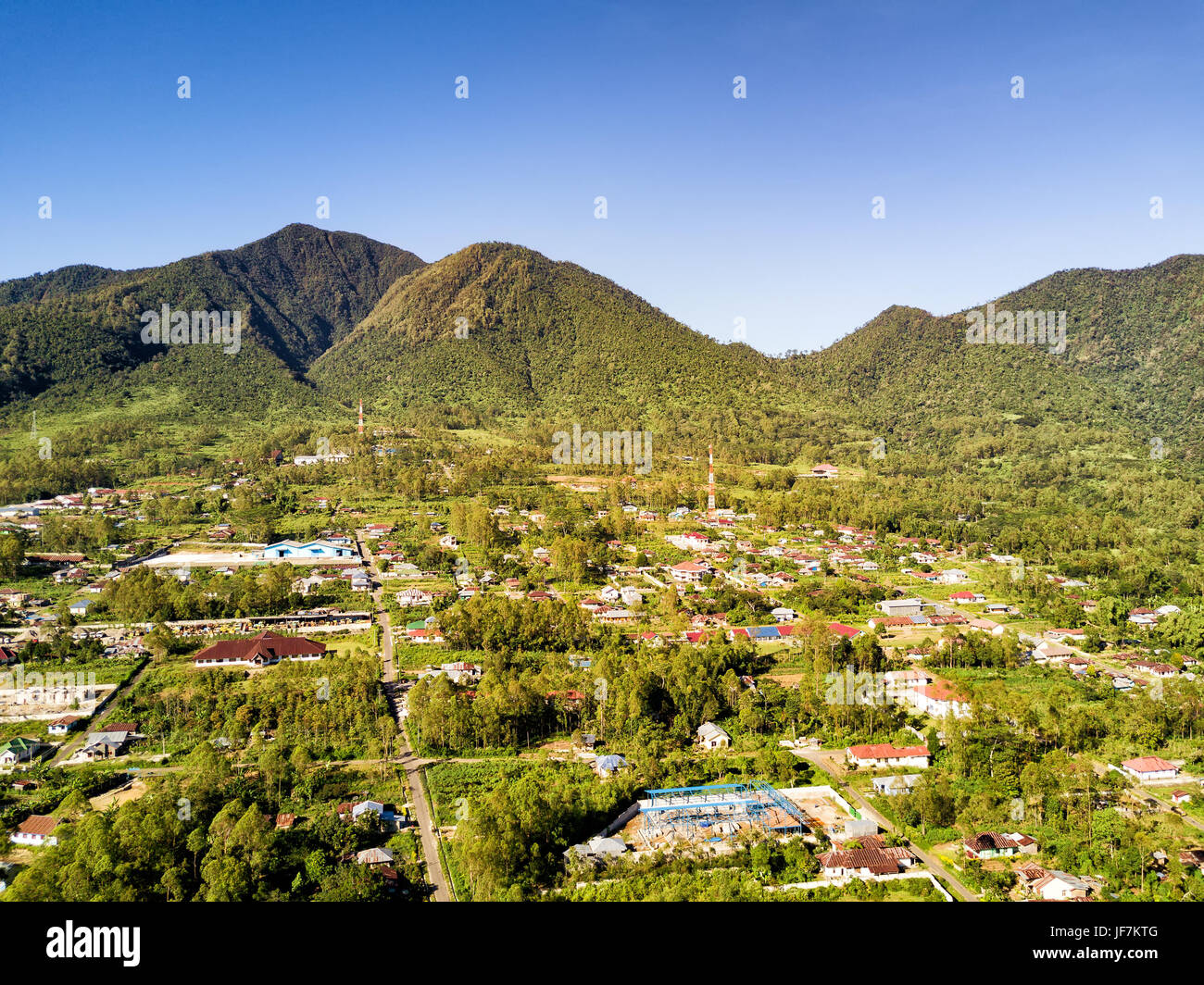 Aerial view of the edge of Ruteng with dramatic mountains in the ...