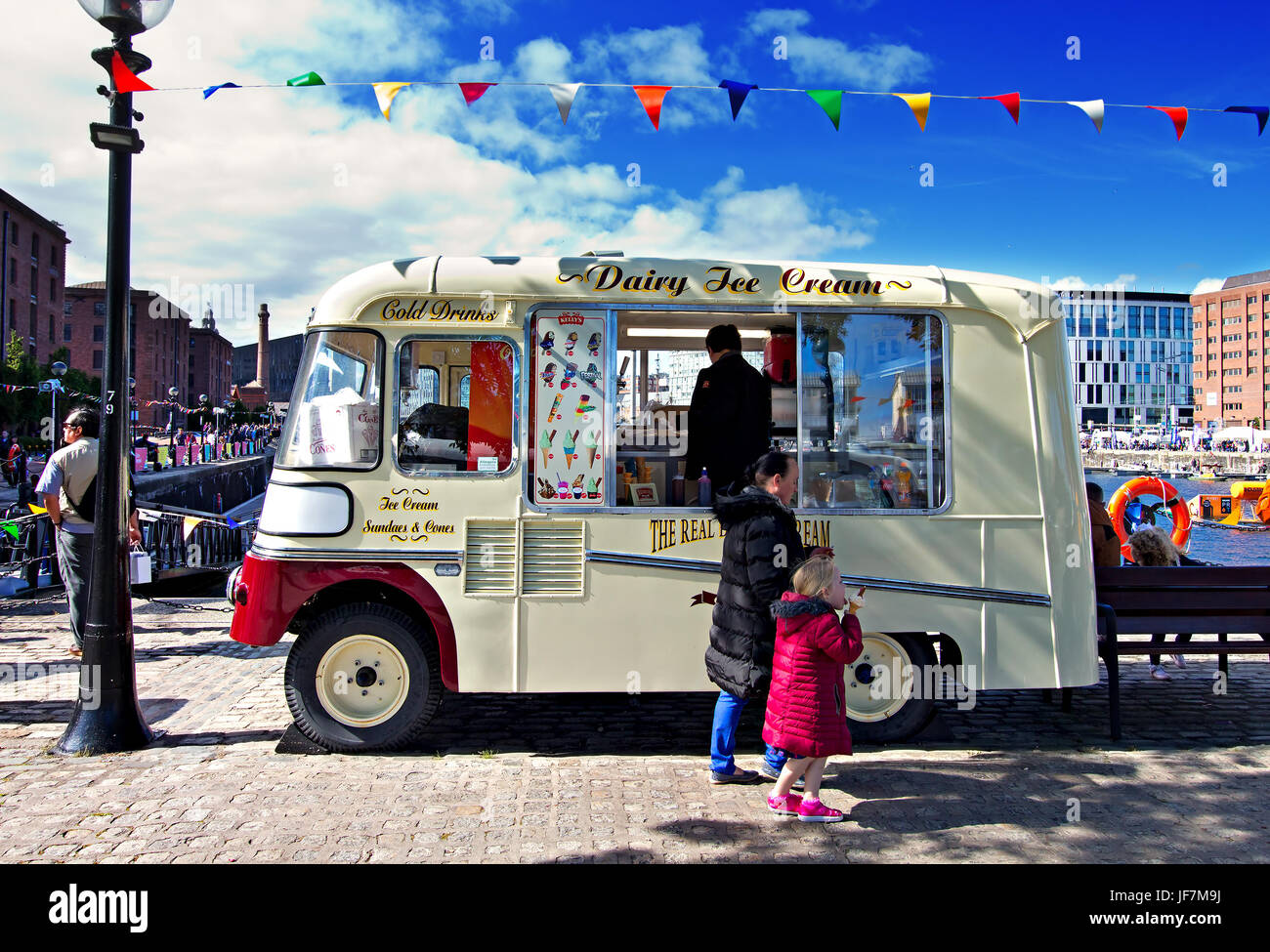Traditional old fashioned British ice cream van with a little girl ...