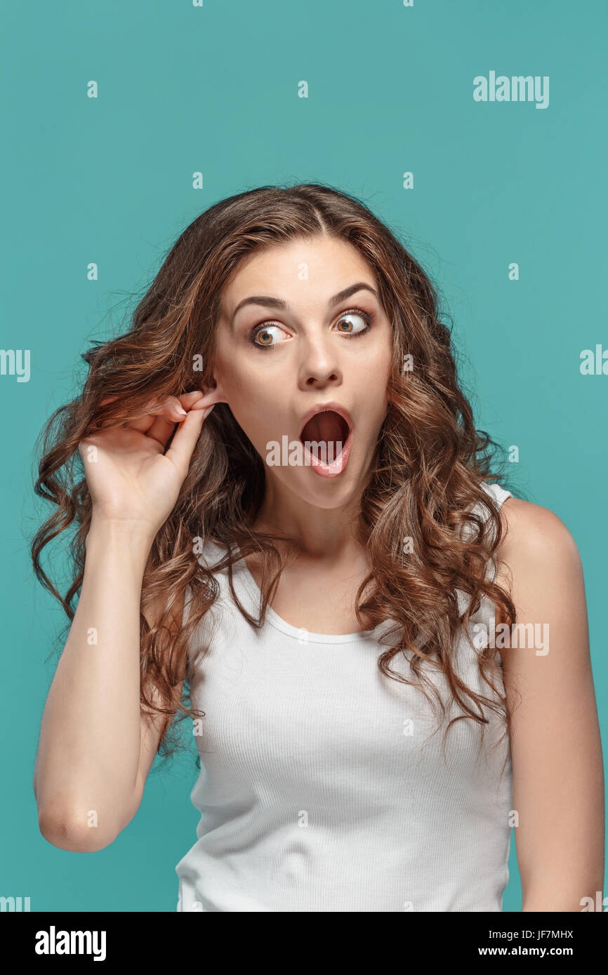 The portrait of young surprised woman with shocked facial expression ...