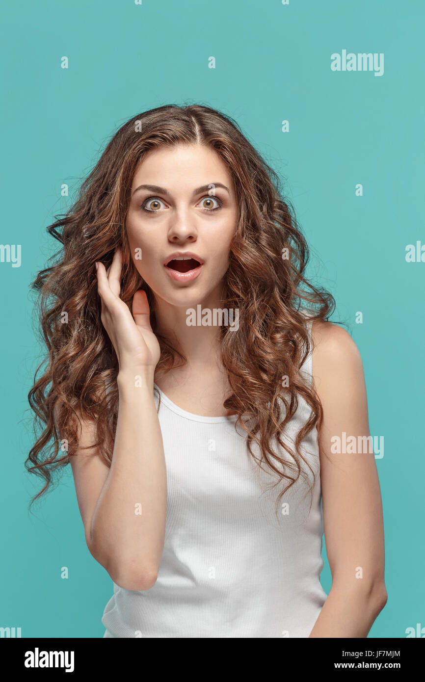 The portrait of young surprised woman with shocked facial expression ...