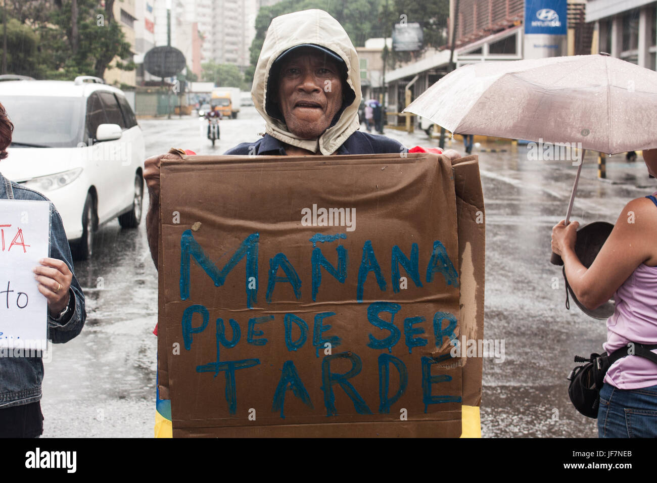 A demonstrator holding a cardboard sign during a protest in Caracas ...