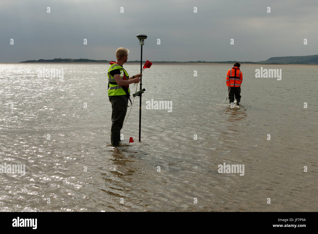 Surveyors perform an RTK based position survey on a buried pipeline ...