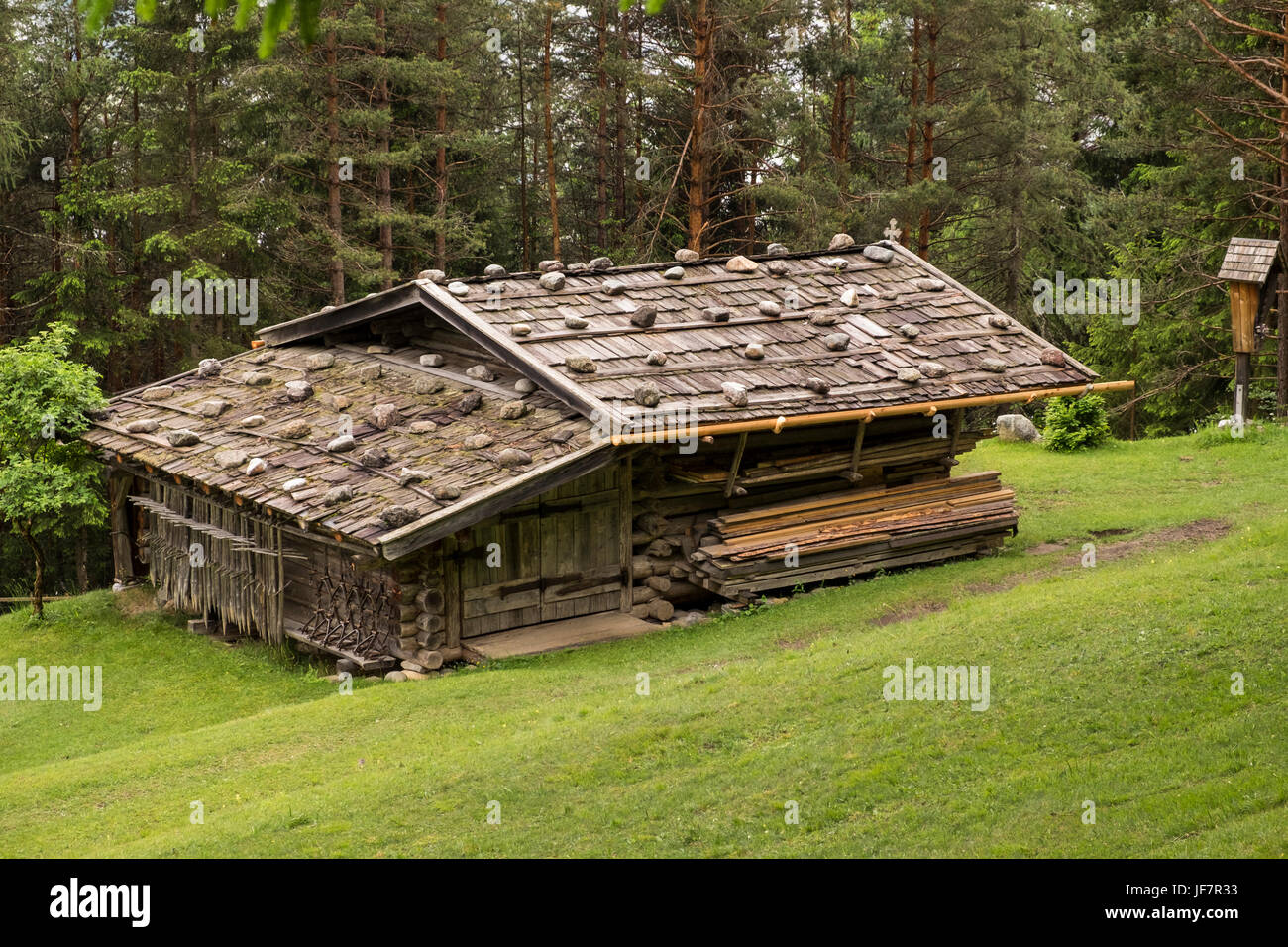 Typical Tyrolean barn, hut, in a meadow with storage for wood, fencing ...