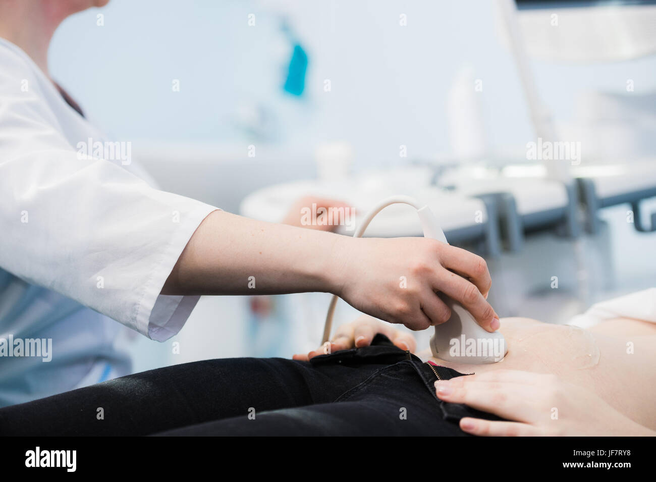 Close-up Of Doctor Moving Ultrasound Probe On Pregnant Woman's Stomach ...