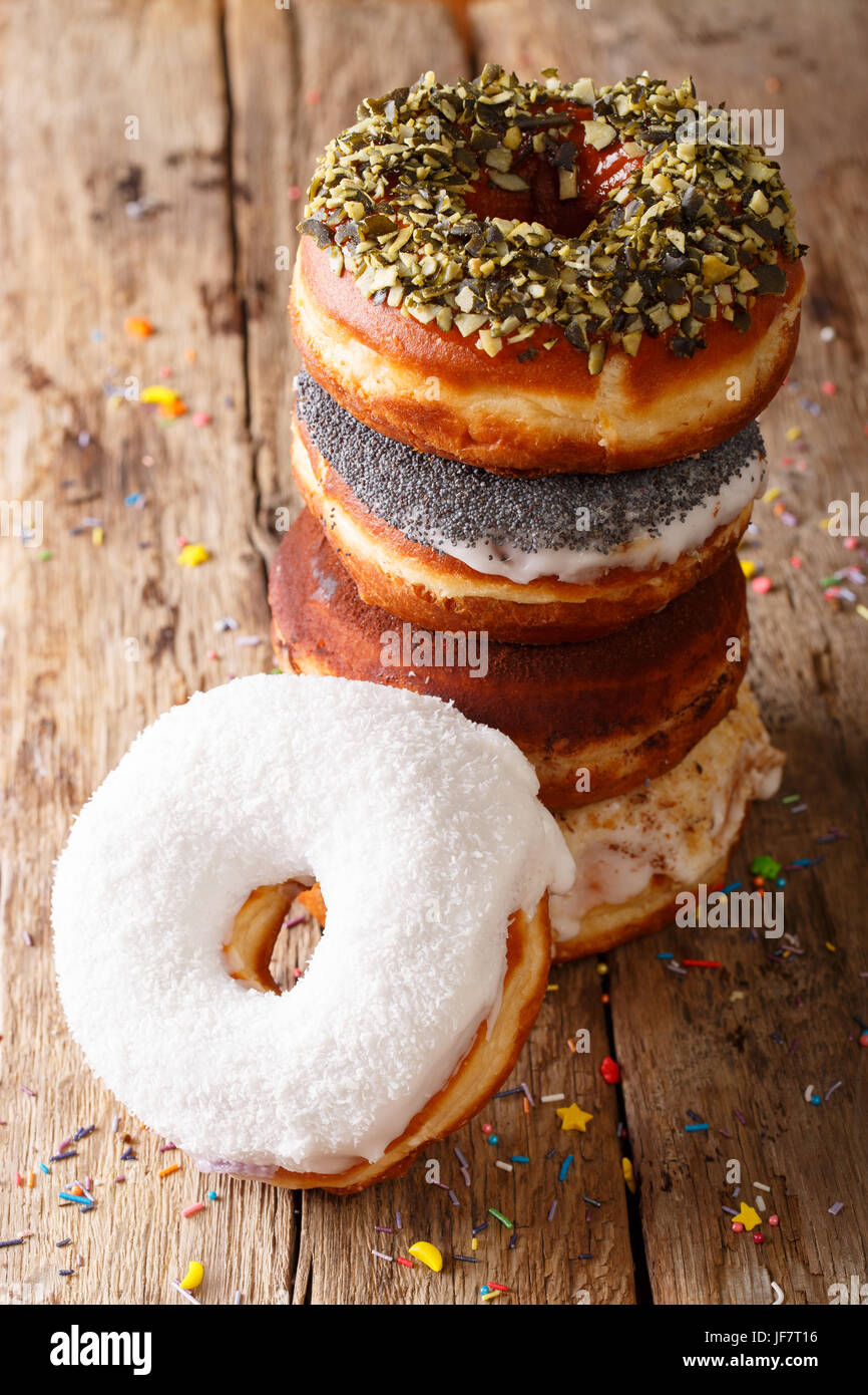stack of glazed multicolored donuts close-up on a table. vertical Stock ...