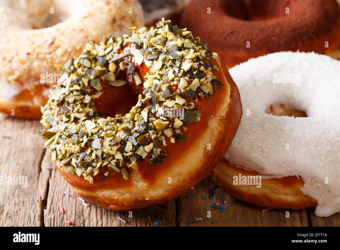 Beautiful donuts with sunflower seeds and coconut close-up on the table ...