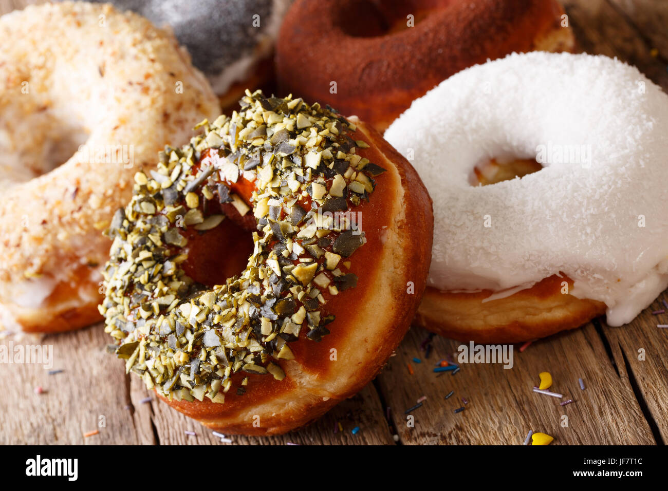 Freshly baked donuts with sunflower seeds and coconut close-up on the ...