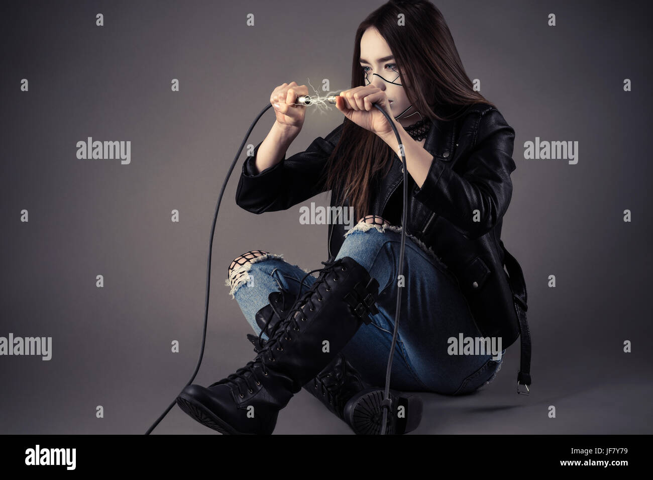 young beautiful robot girl connects two electric cables Stock Photo - Alamy