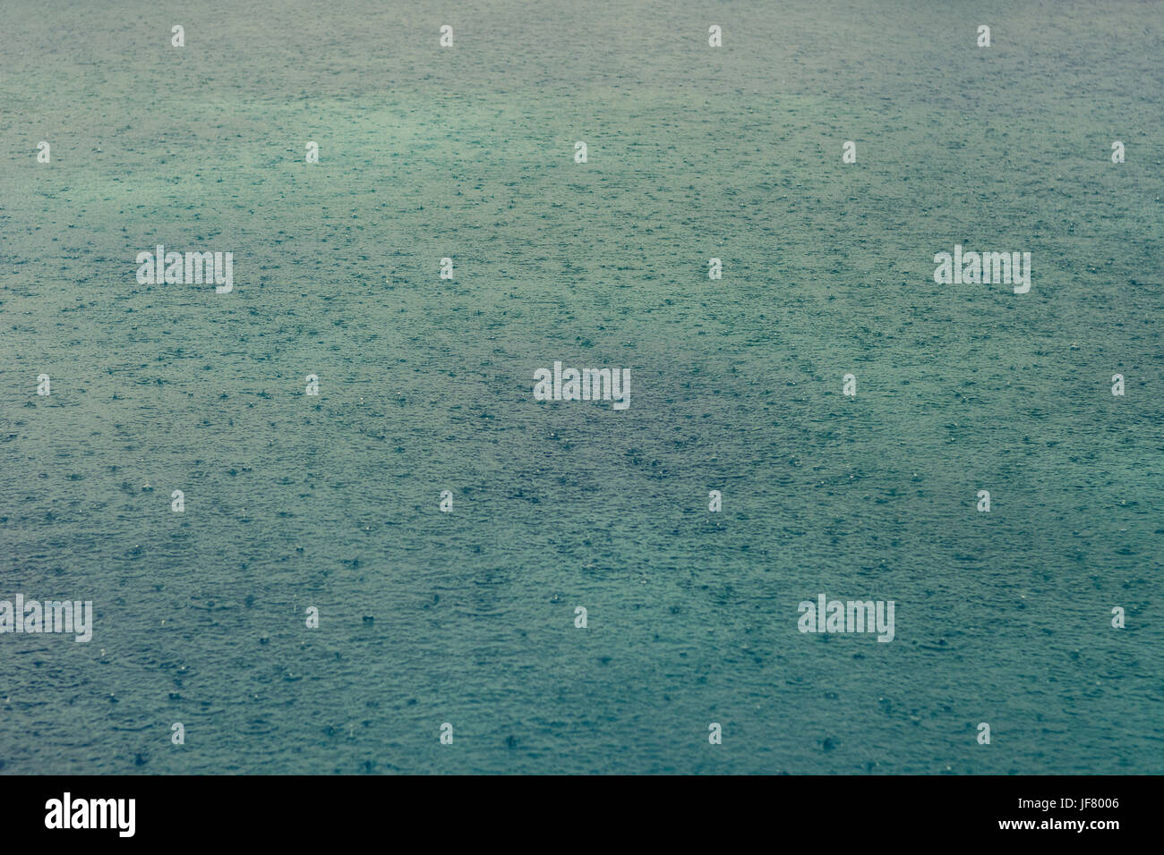 Rain drops on lake surface Stock Photo - Alamy