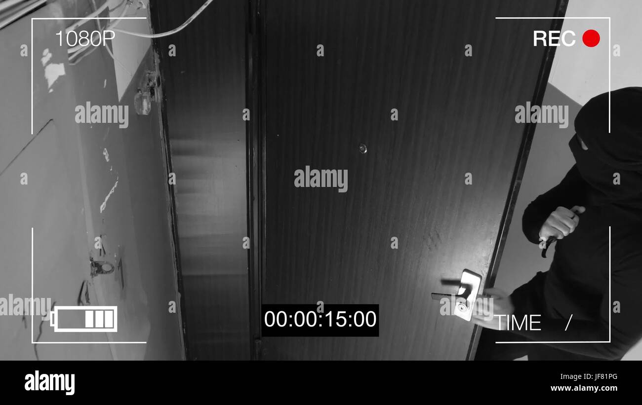 the masked robber c with a knife broke into the apartment. CCTV camera ...