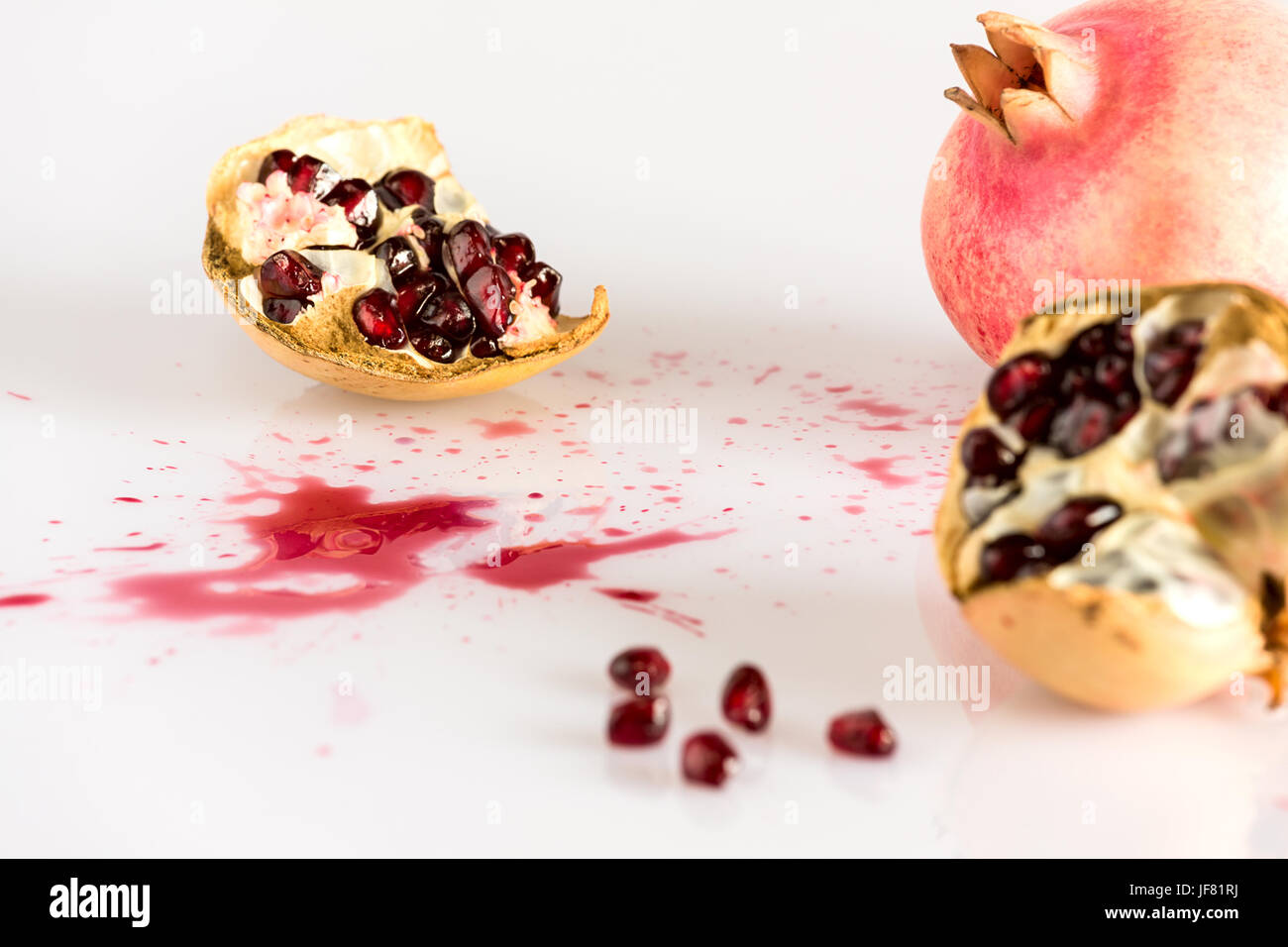 Half pomegranate and seeds Stock Photo - Alamy