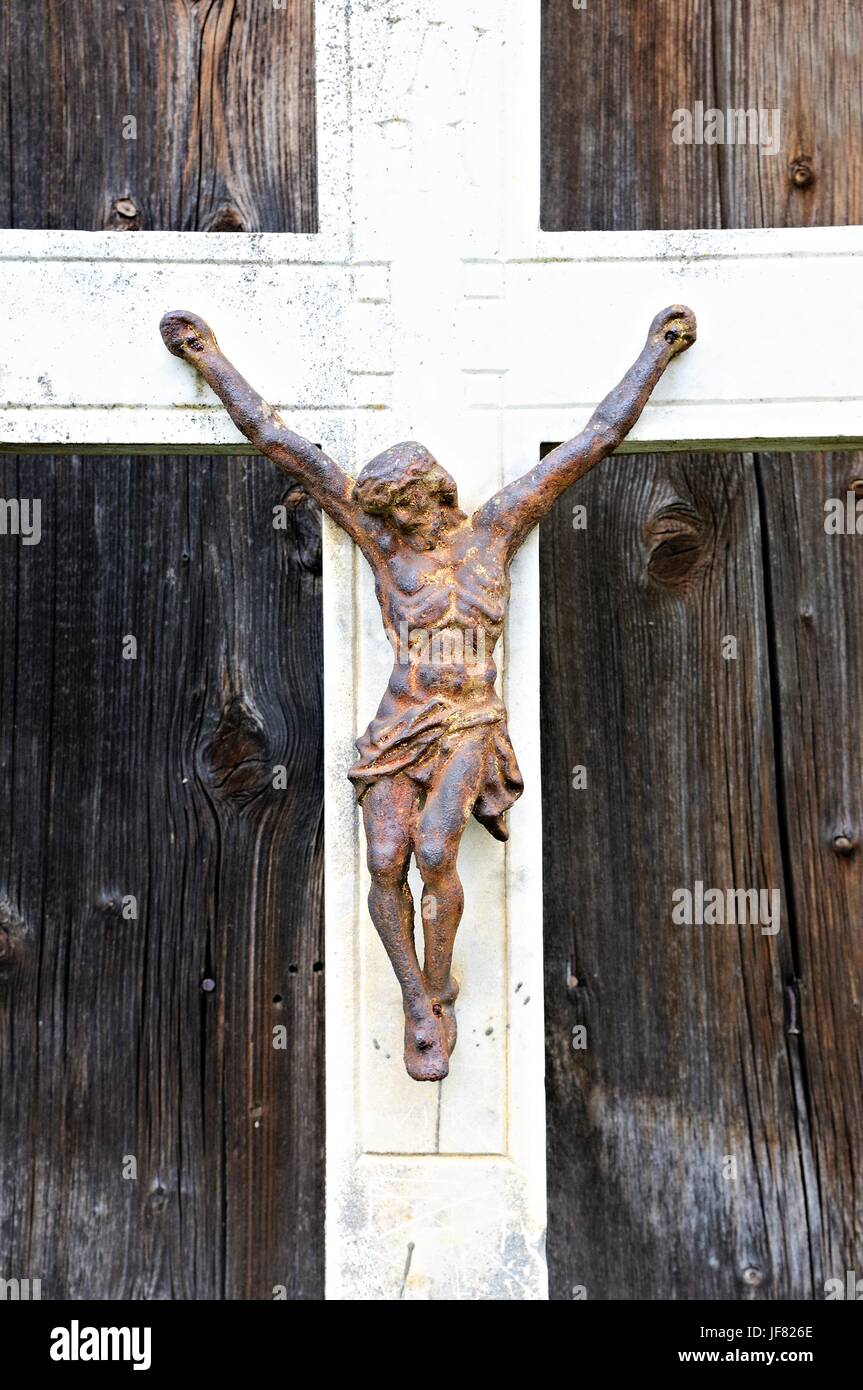 Stone cross with rusty Christ Stock Photo - Alamy