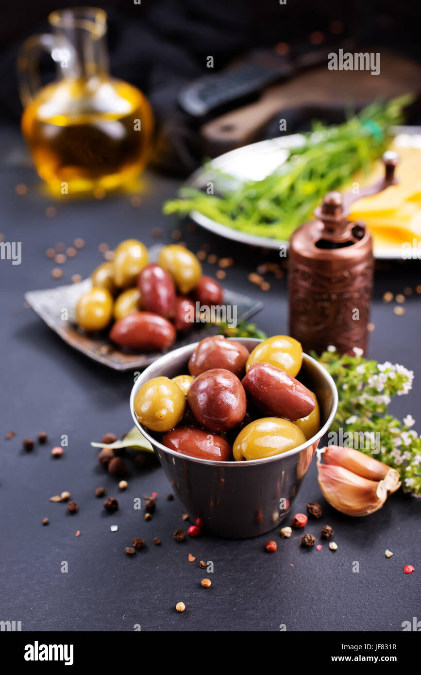 olives with spice in metal bowl and on a table Stock Photo - Alamy