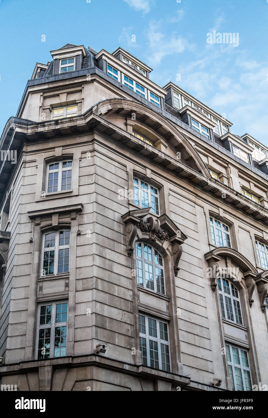 Old Cut Stone Building on Angle with Mansard Roof Stock Photo - Alamy
