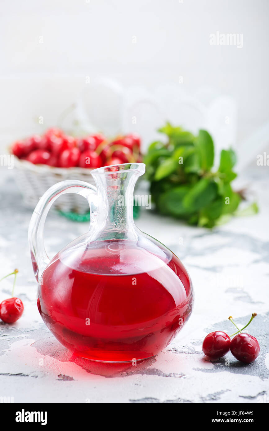 cherry juice in jug and on a table Stock Photo - Alamy