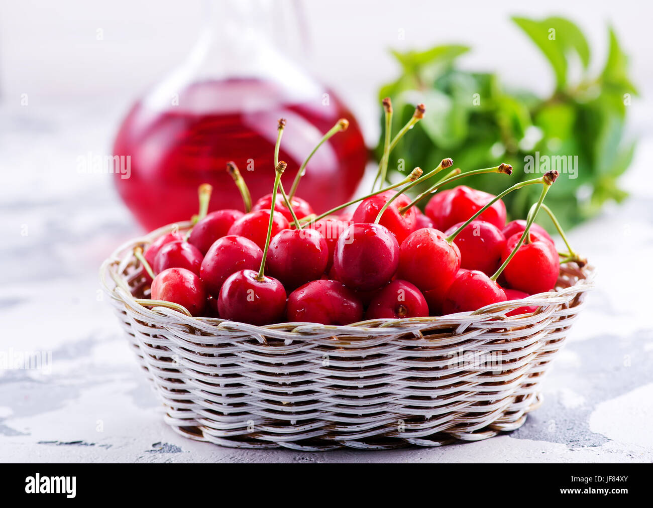 fresh cherry in basket and on a table Stock Photo - Alamy