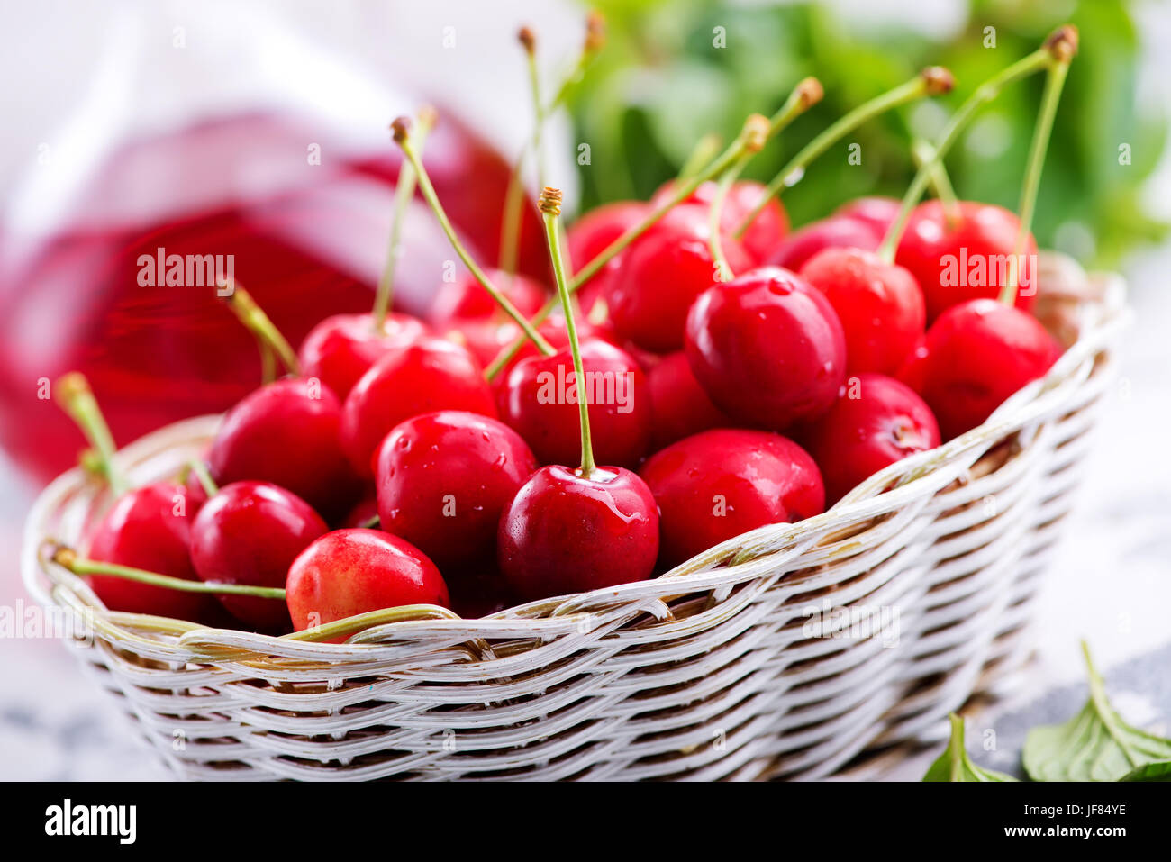 fresh cherry in basket and on a table Stock Photo - Alamy