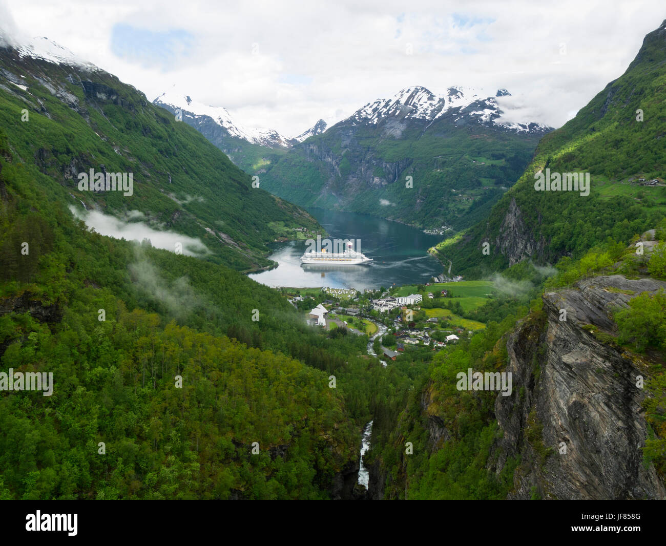 View down to Geiranger village and cruise ship in Geirangerfjord from ...