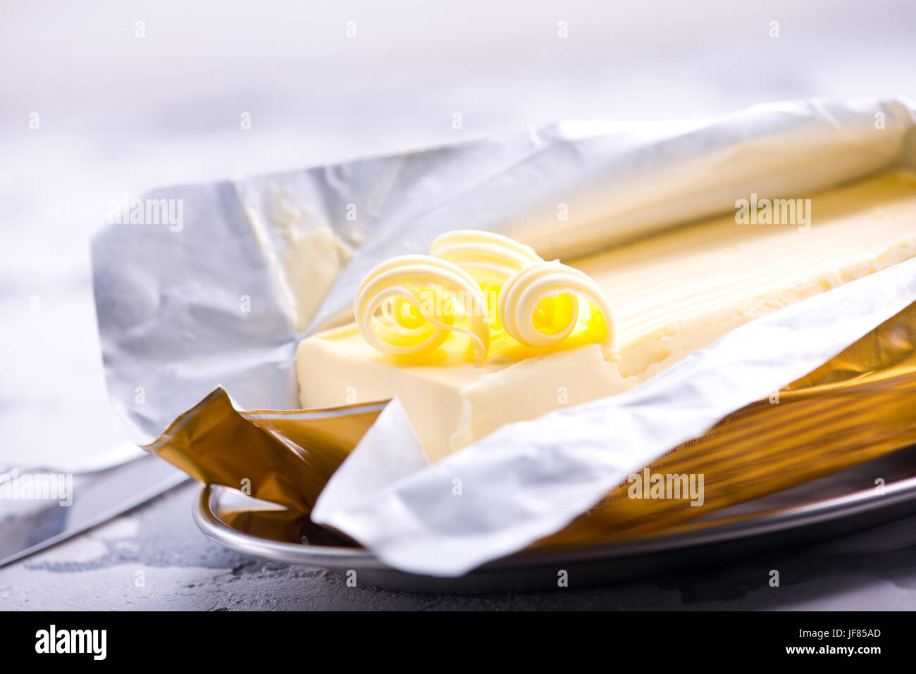 butter on plate and on a table Stock Photo - Alamy