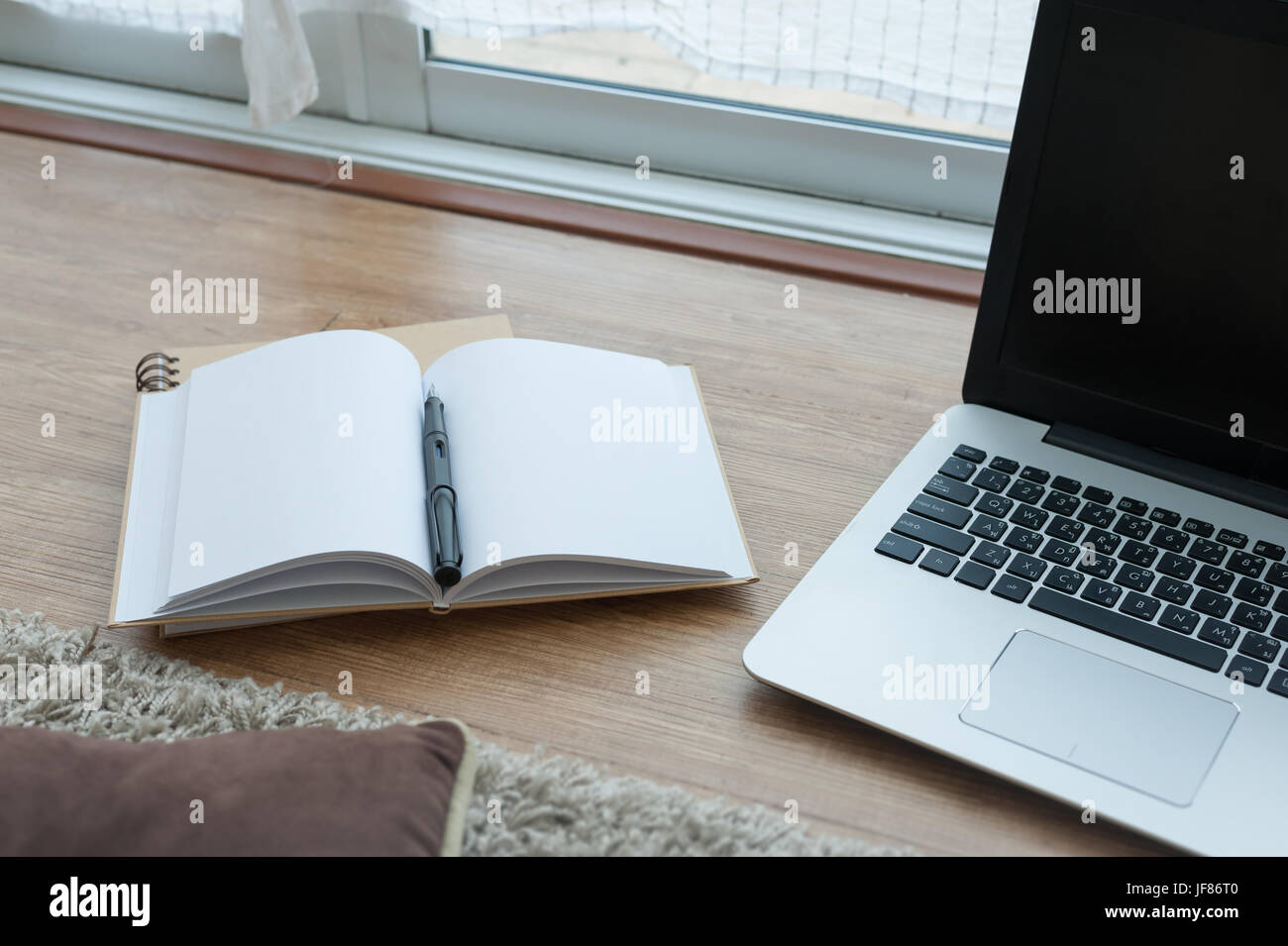 Notebook and laptop computer on wood floor. Portable and mobile devices ...