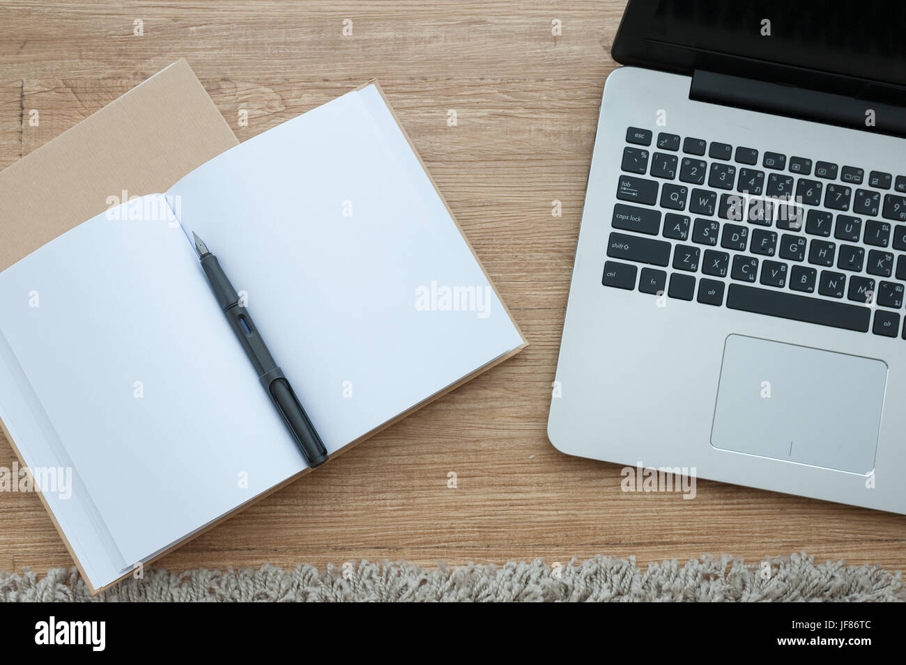 Top view of notebook and laptop computer on wood floor. Portable and ...