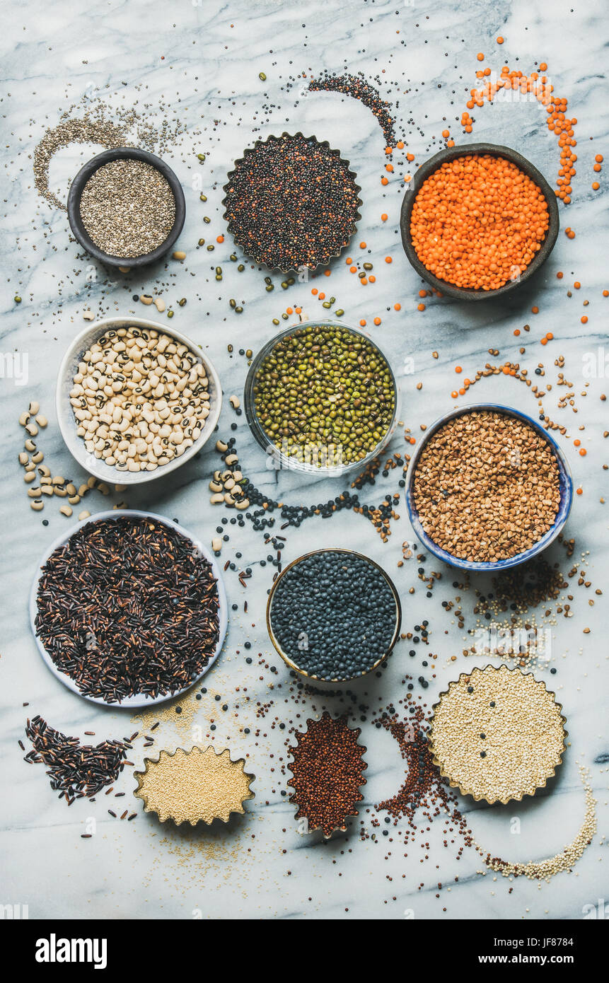 Variety of raw grains, beans, cereals over grey marble background Stock ...