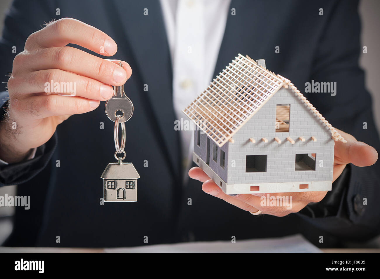 Real estate agent handing over house keys Stock Photo - Alamy