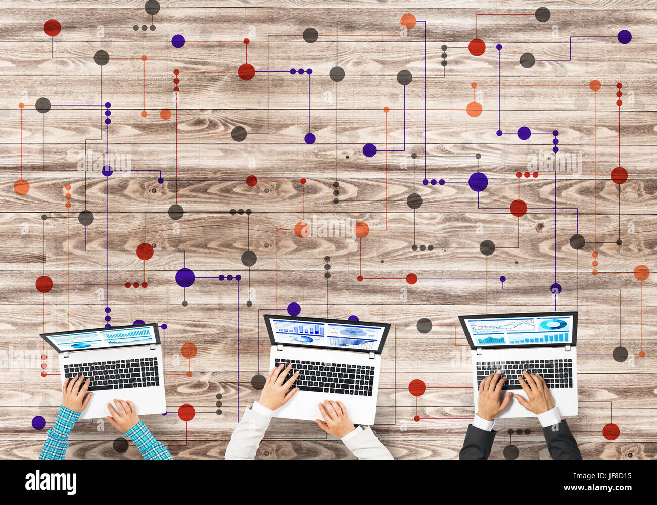 Group of three people with devices in hands working together as symbol ...