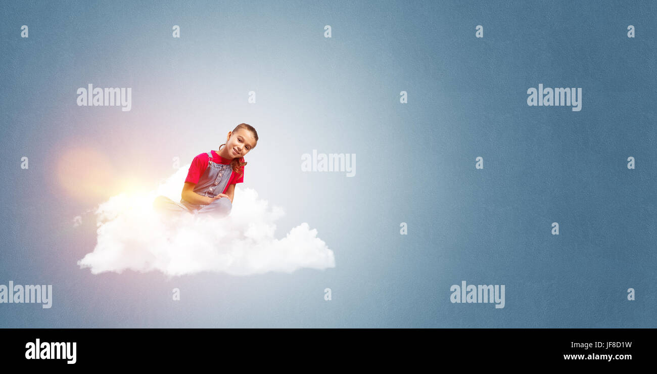 Cute kid girl sitting on cloud against blue color background Stock ...