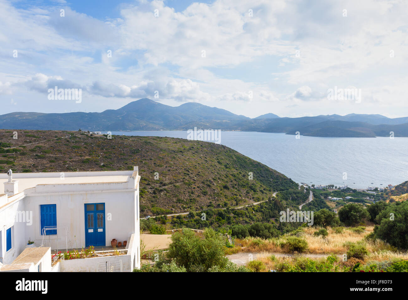 Typical Greek house on a hill sloping down the sea in village of ...
