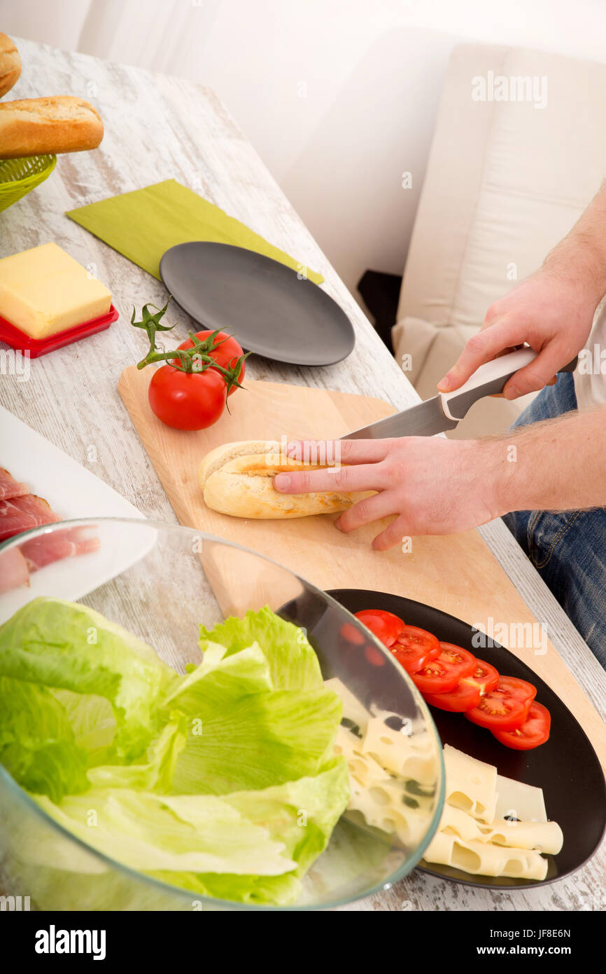 Young man preparing a Sandwich Stock Photo - Alamy