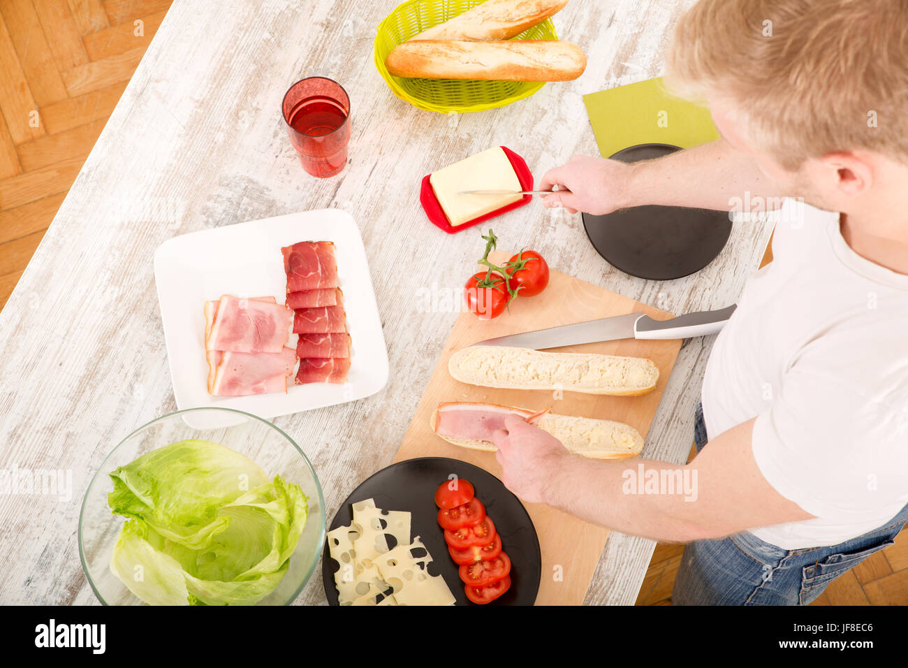 Young man preparing a Sandwich Stock Photo - Alamy