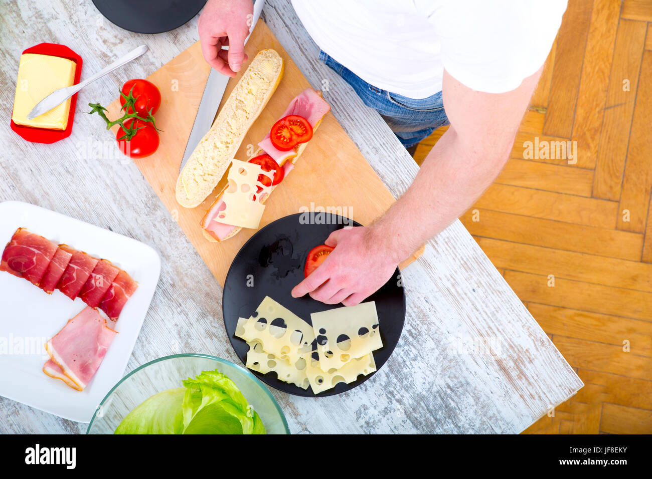 Young man preparing a Sandwich Stock Photo - Alamy