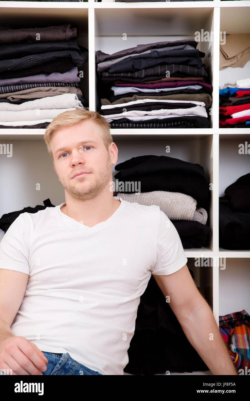 Young man with his wardrobe Stock Photo - Alamy
