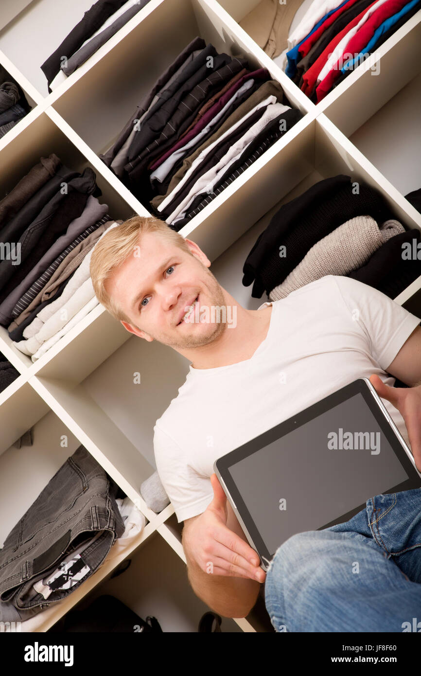 Young man with his wardrobe Stock Photo - Alamy