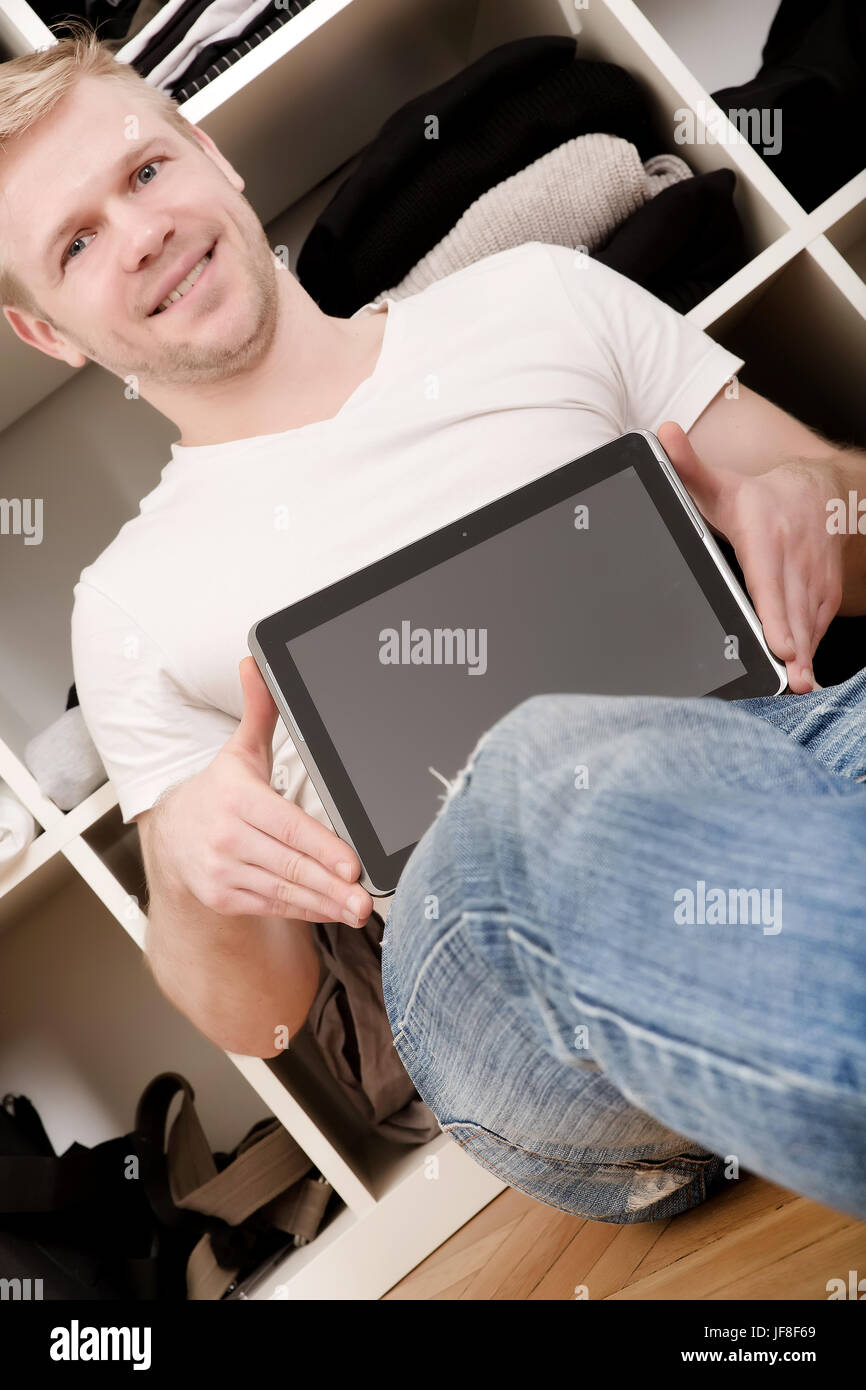Young man with his wardrobe Stock Photo - Alamy