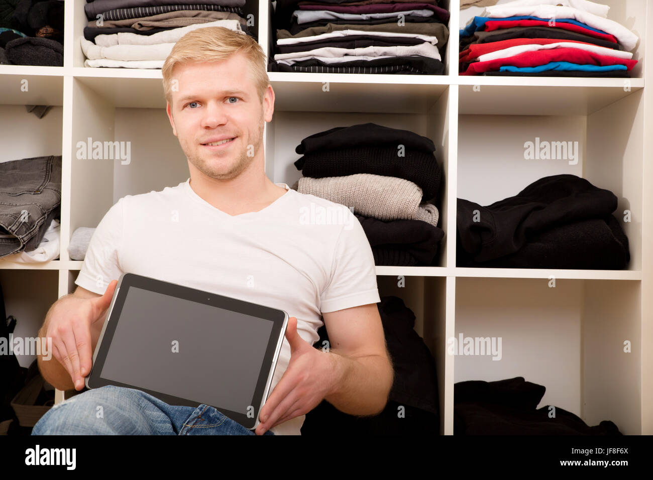 Young man with his wardrobe Stock Photo - Alamy