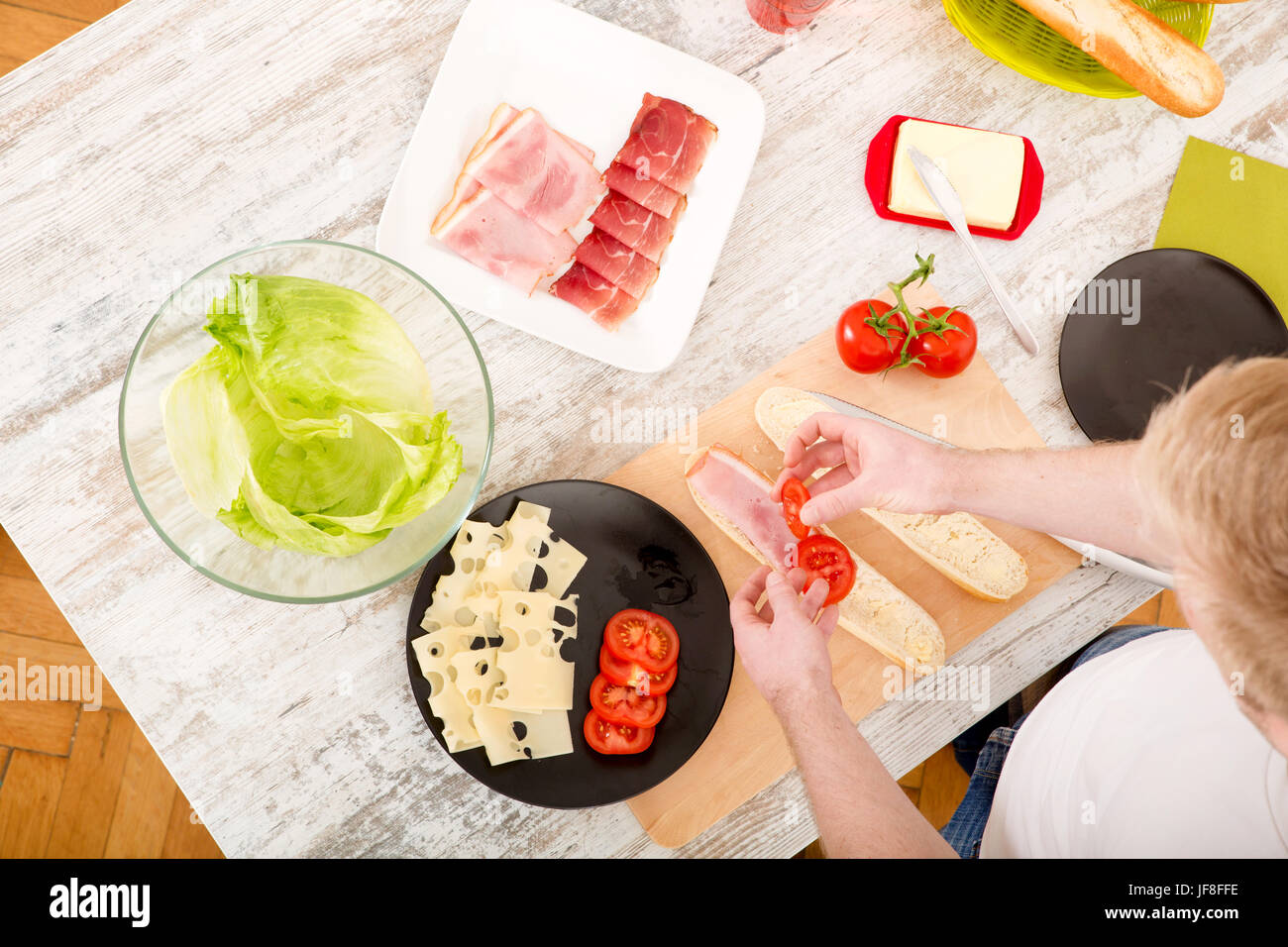 Young man preparing a Sandwich Stock Photo - Alamy