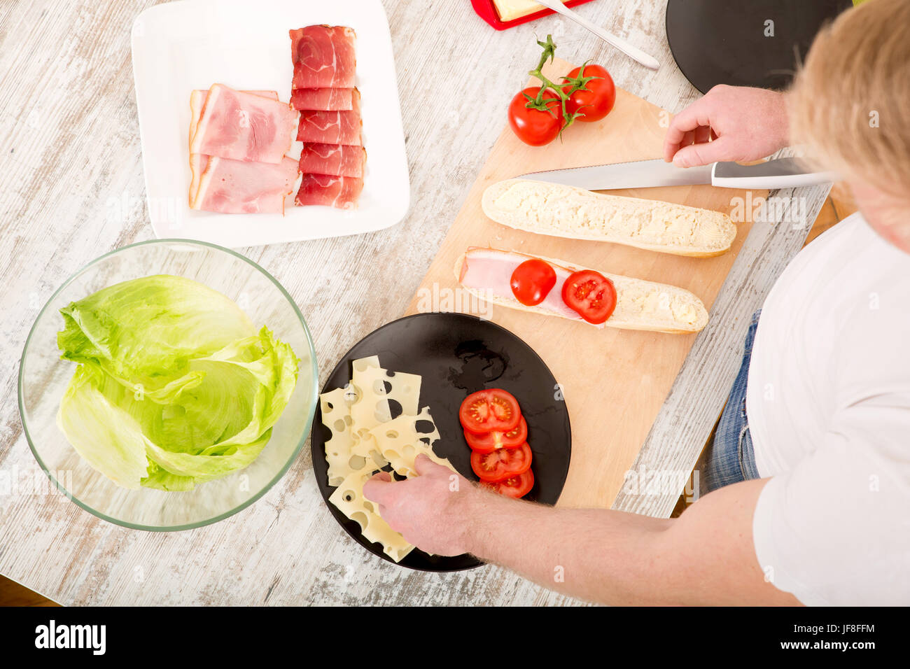 Young man preparing a Sandwich Stock Photo - Alamy