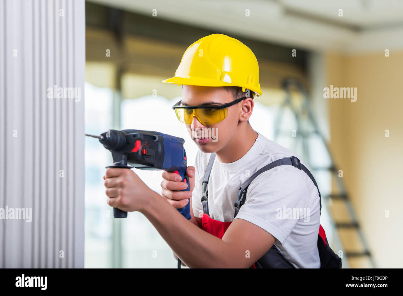 Man drilling the wall with drill perforator Stock Photo - Alamy