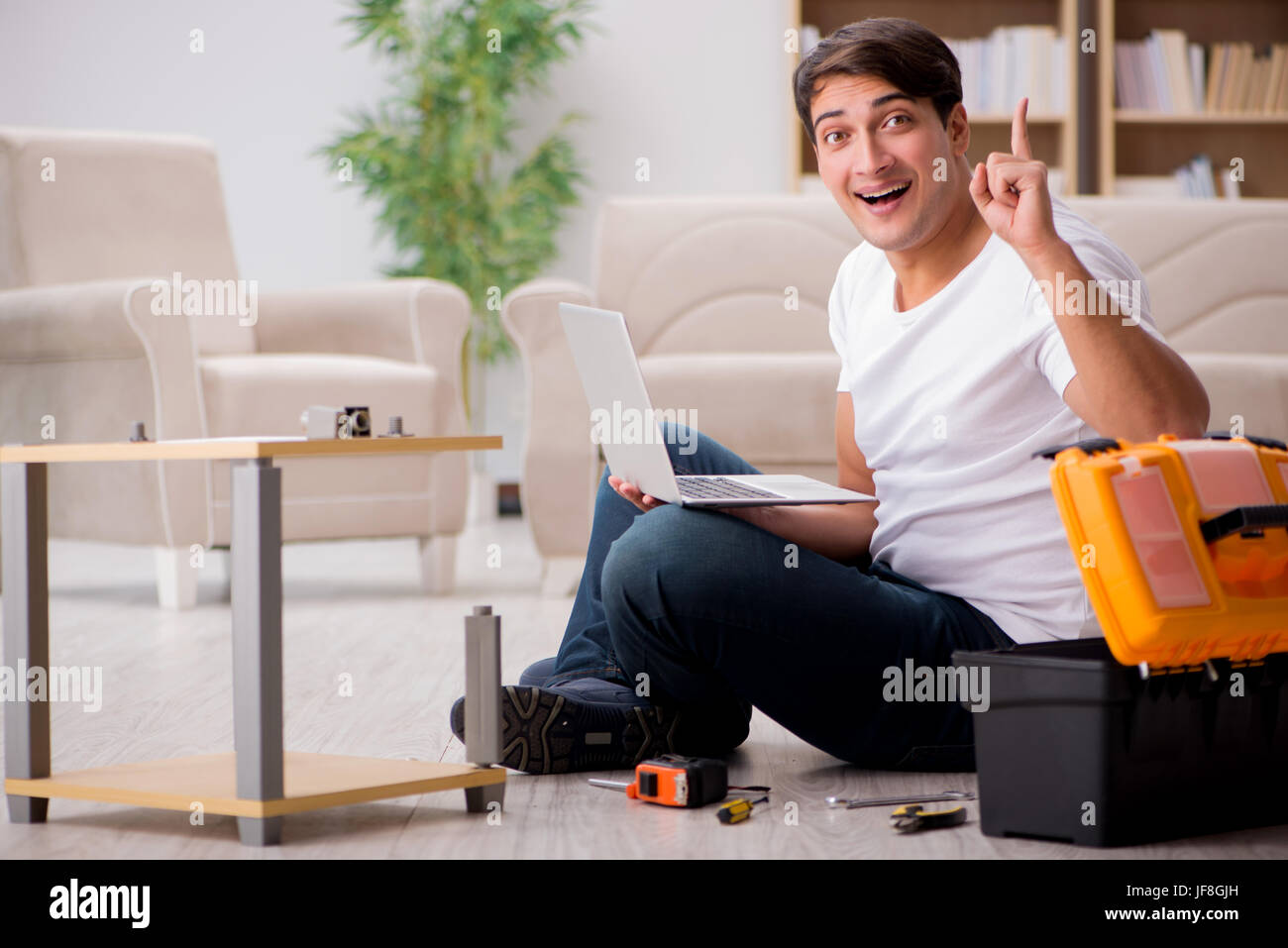 Man assembling shelf at home Stock Photo - Alamy