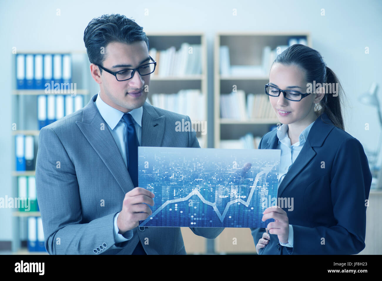 Business people discussing stock chart trends Stock Photo - Alamy