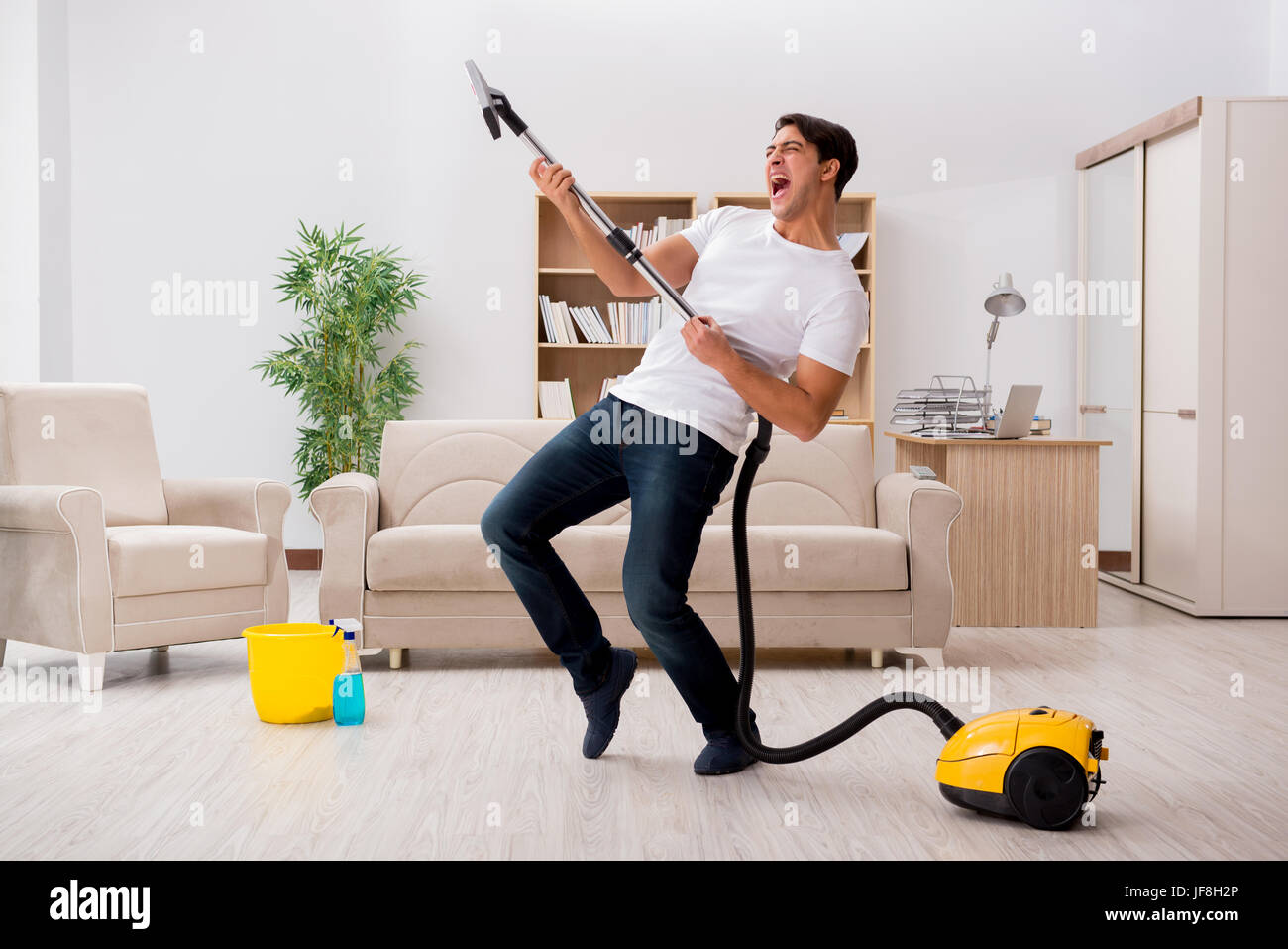 Man cleaning home with vacuum cleaner Stock Photo - Alamy