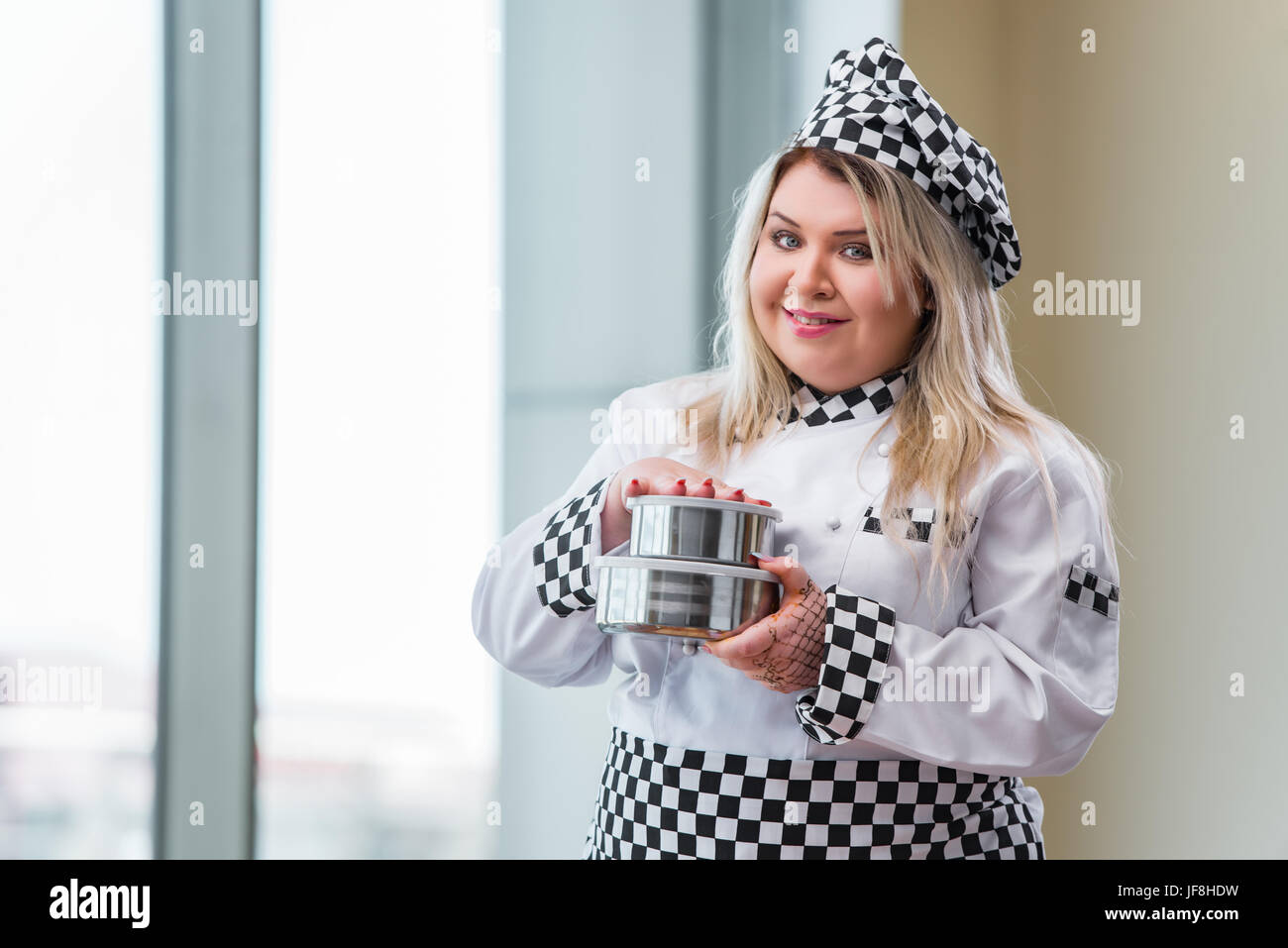 Woman cook working in the bright kitchen Stock Photo - Alamy